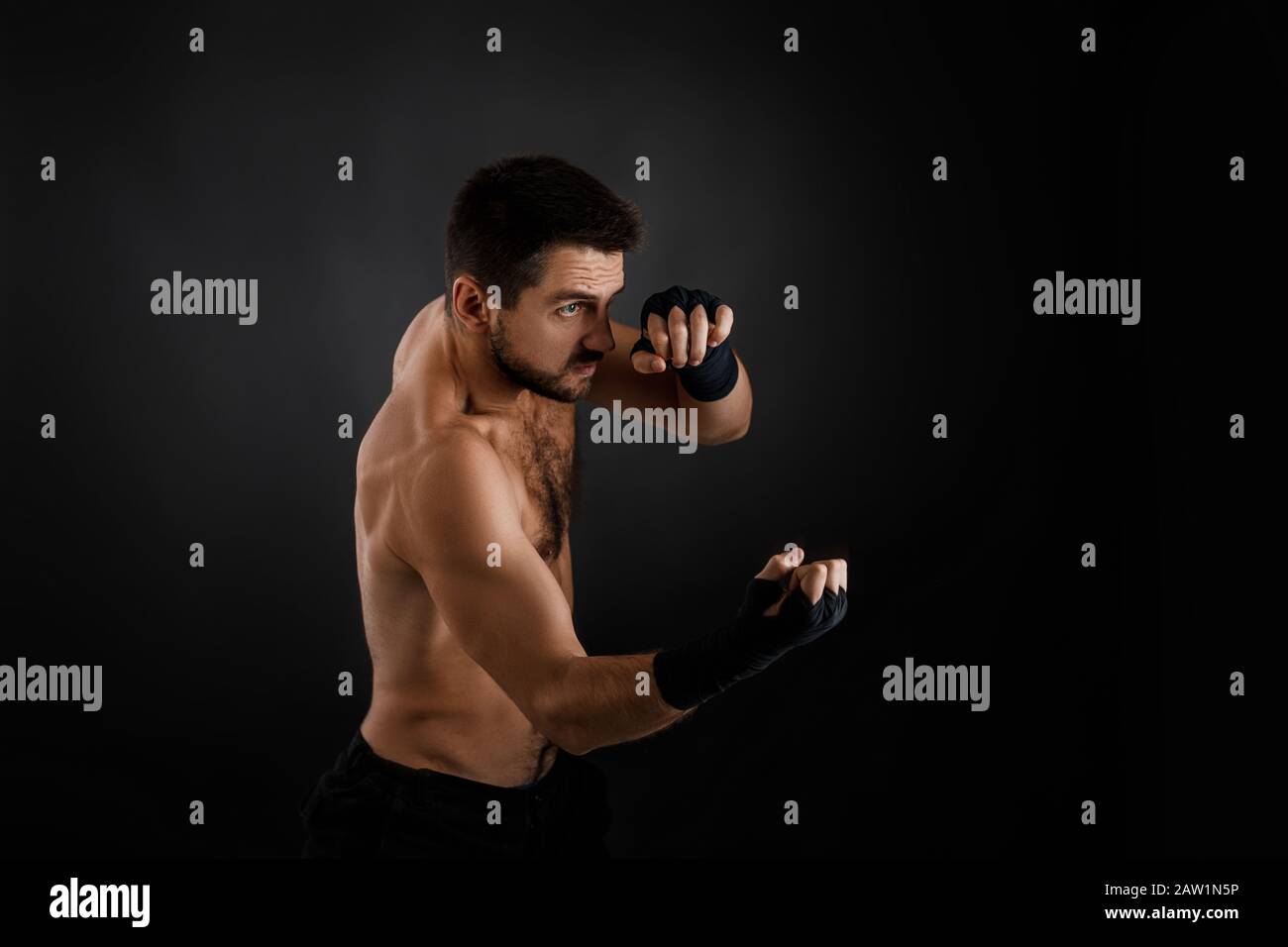 Sportsman boxer throwing a fierce and powerful punch. muscular man on ...