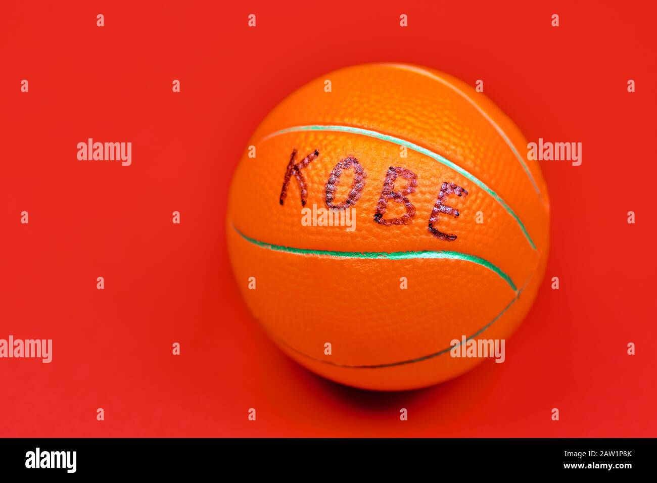 Basketball ball with KOBE text, red background, copy space. Famous ...