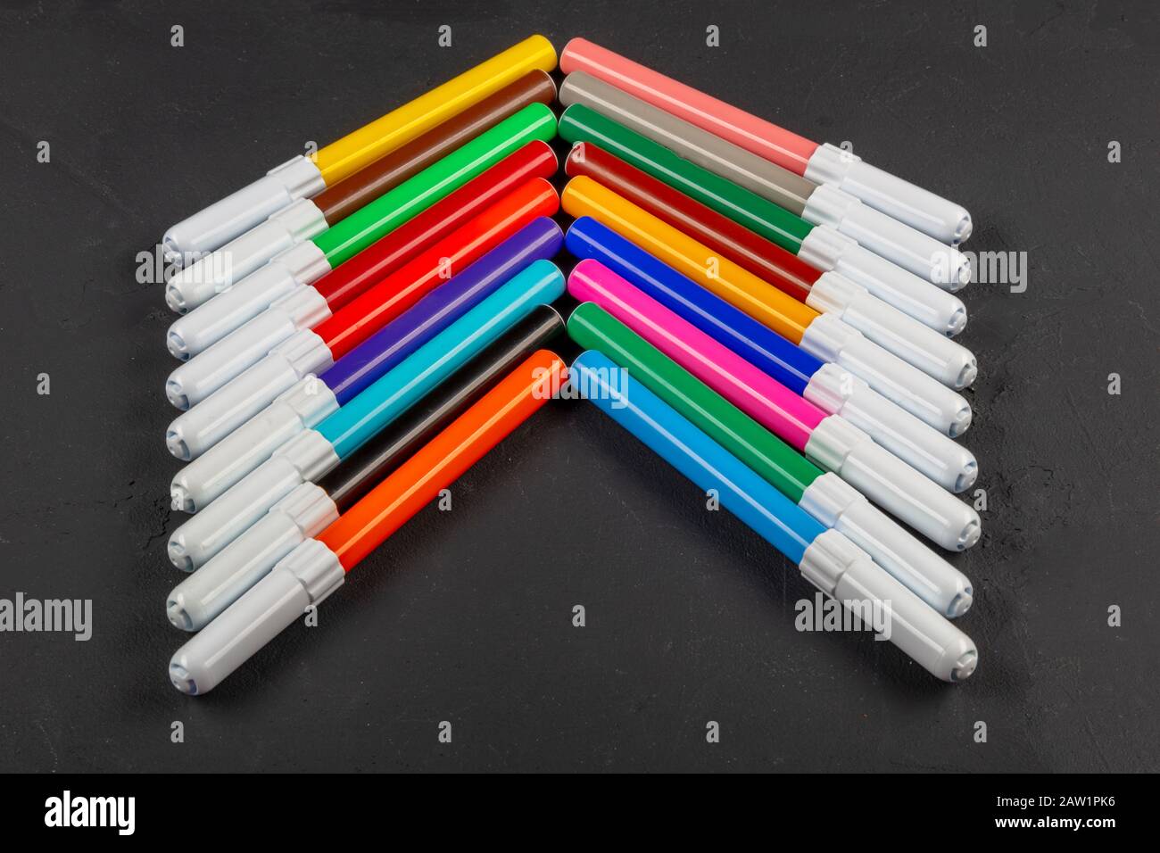Colorful felt-tip pens on black wooden floor. School - Education ...