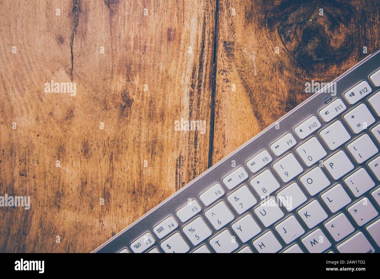 Office concept. Modern workspace, keyboard of a computer on dark wooden ...