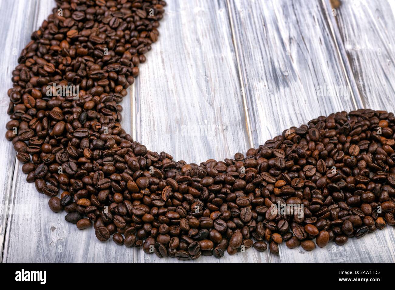 Coffee beans stacked on the white, wooden and old background Stock ...