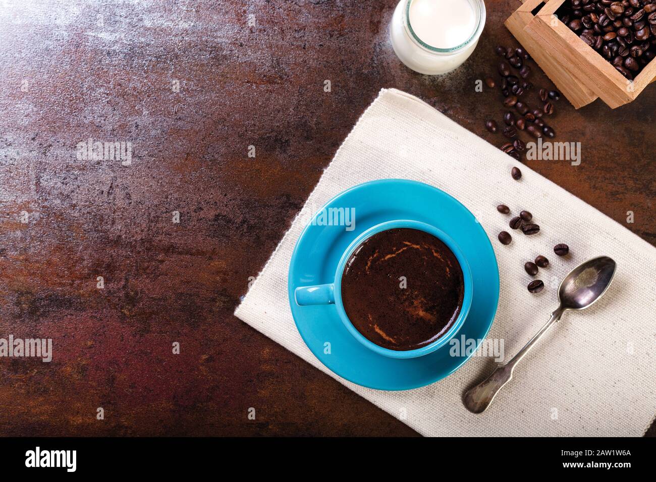 Cup of coffee and wooden containers filled with cofee beans on the rust ...