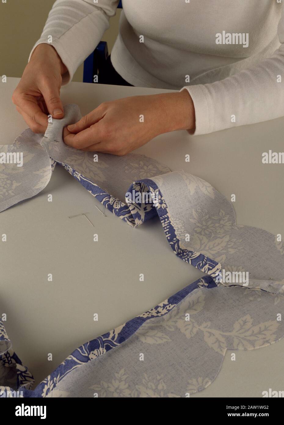 Adding trimming to round table cloth - steps Stock Photo - Alamy