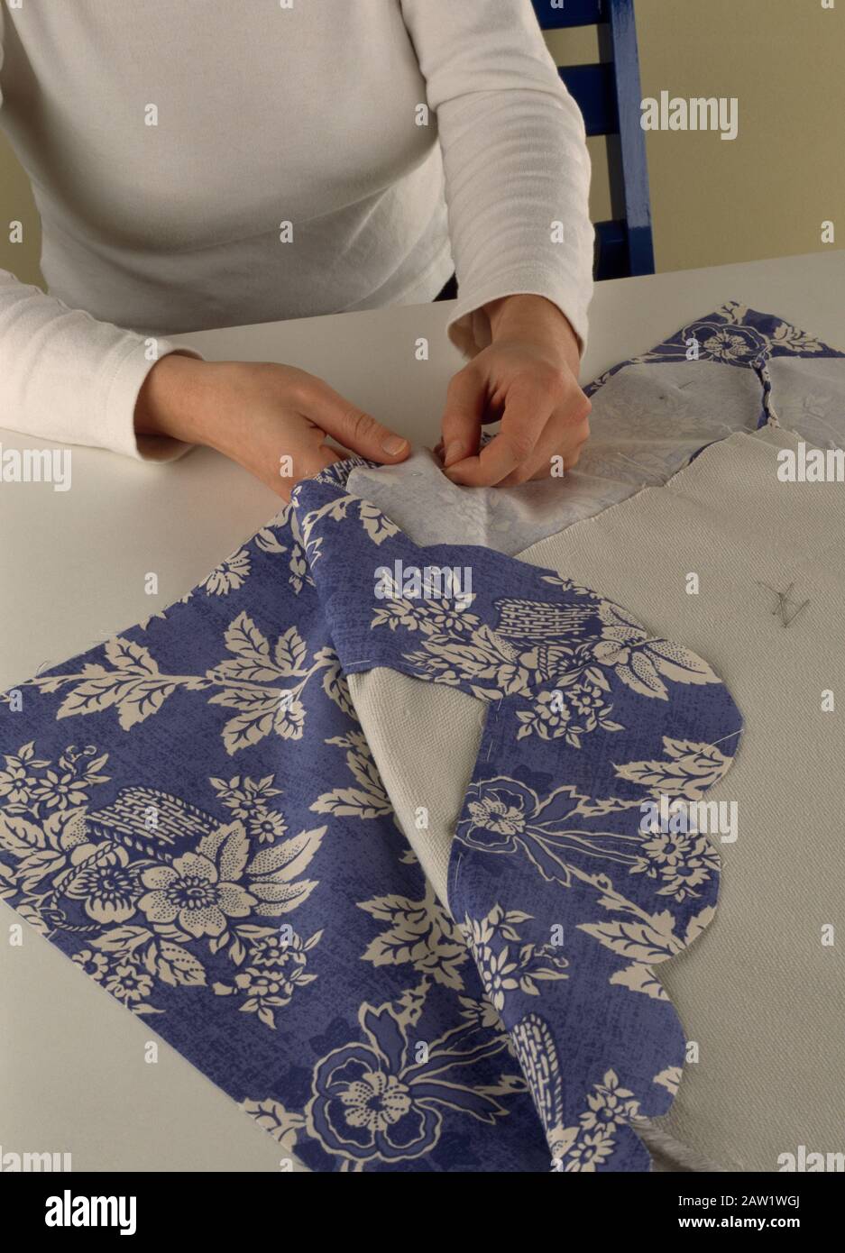 Adding trimming to round table cloth Stock Photo - Alamy
