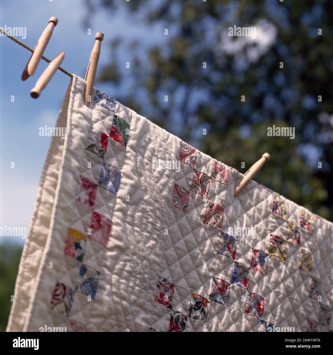 Quilt drying on washing line in fresh air Stock Photo - Alamy