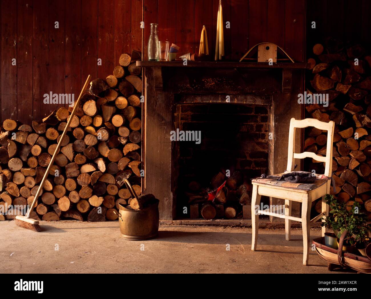 Open fireplace with logs stored either side Stock Photo - Alamy