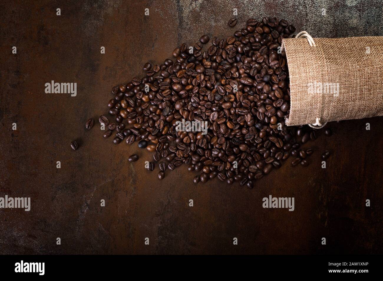 Coffee seeds with some jute bags filled with coffee beans. Jute bags ...