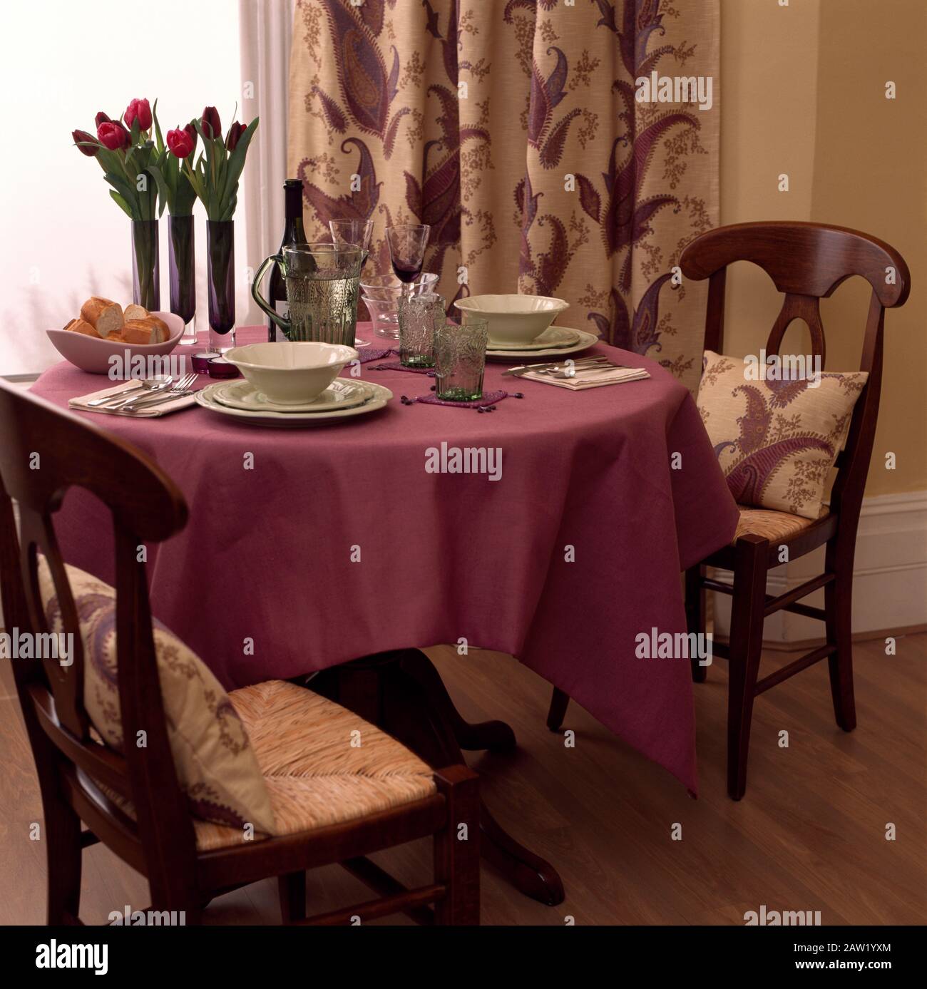round dining table with red cloth Stock Photo - Alamy