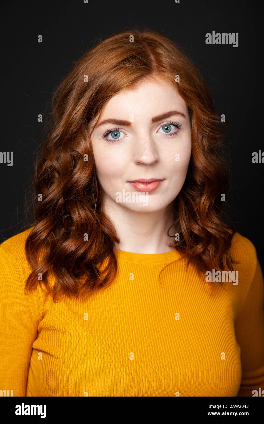 Portrait of a beautiful red headed woman looking towards camera Stock ...