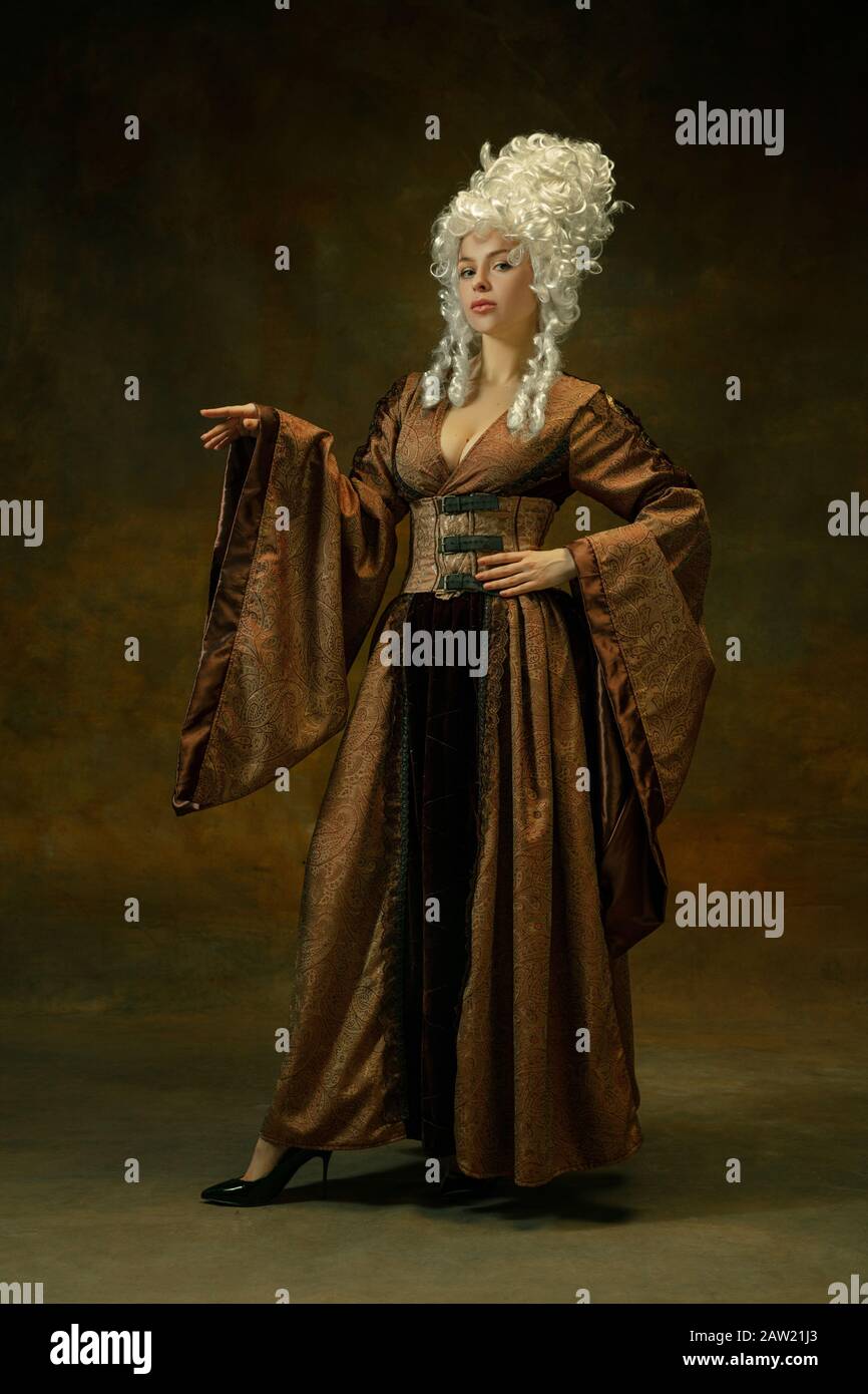 Elegance posing. Portrait of medieval young woman in brown vintage ...