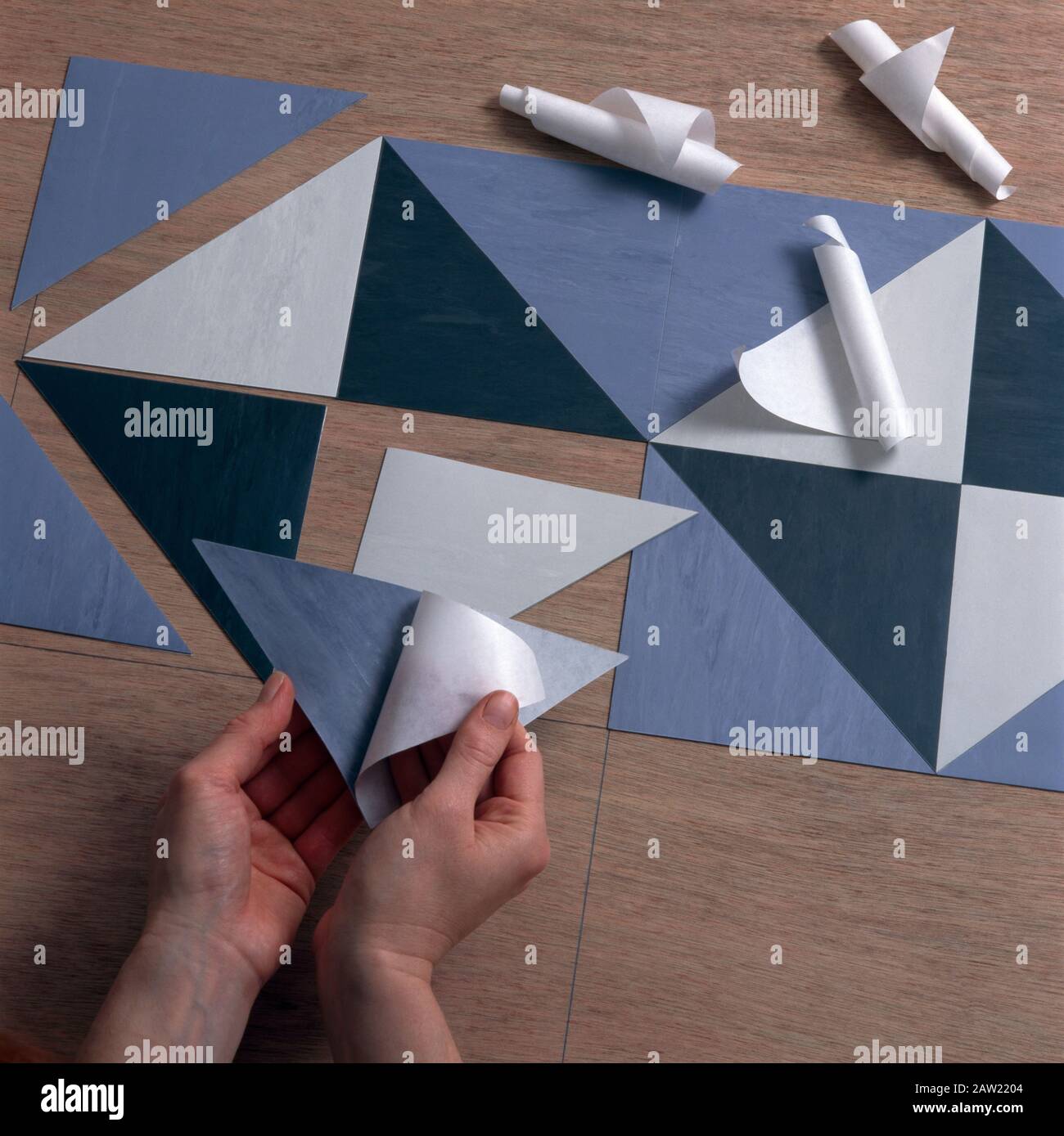 Close-up of hands peeling off masking paper Stock Photo - Alamy