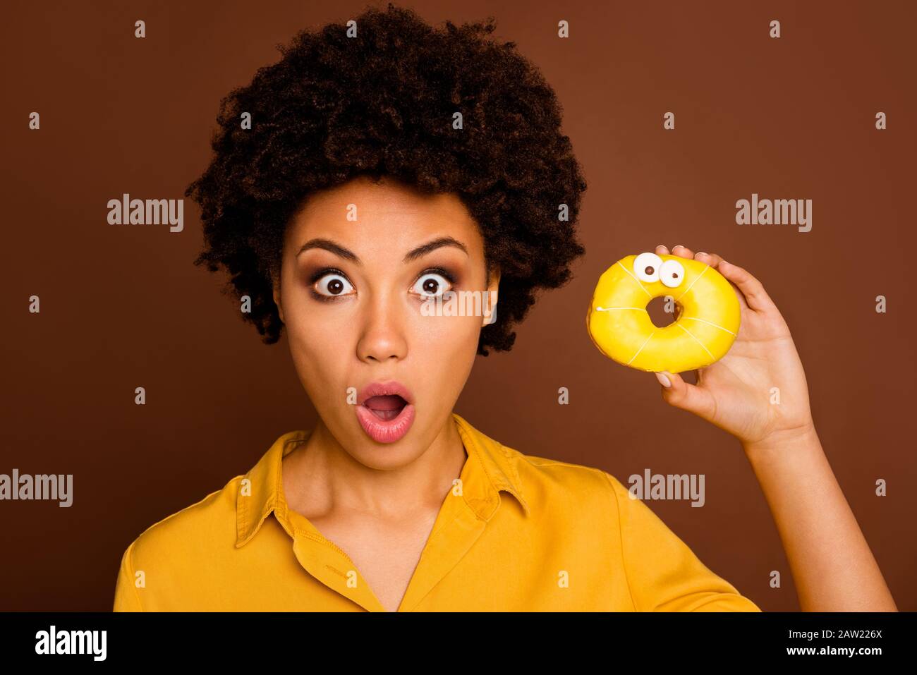 This cake can speak. Closeup photo of shocked dark skin lady hold ...