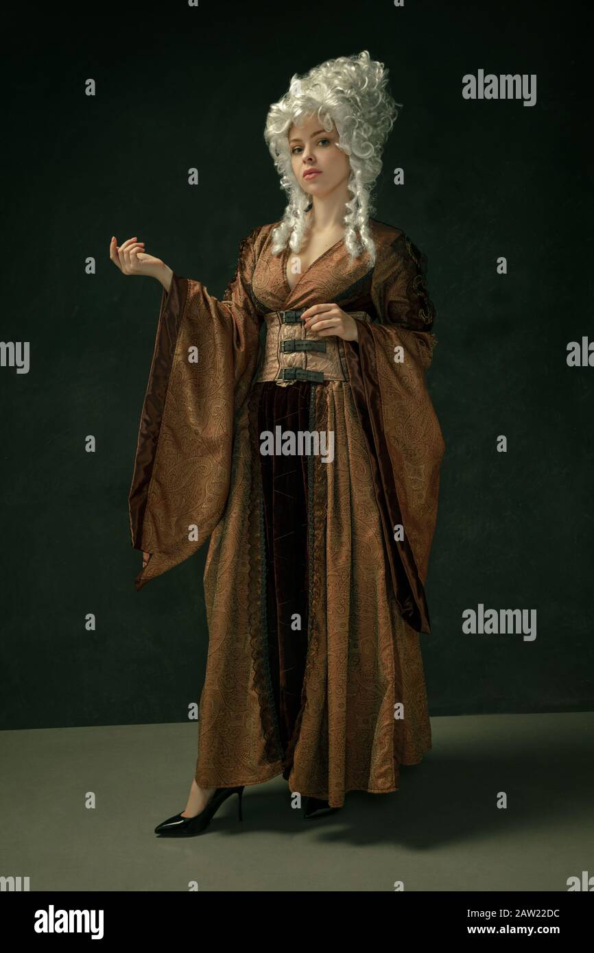 Elegance posing. Portrait of medieval young woman in brown vintage ...