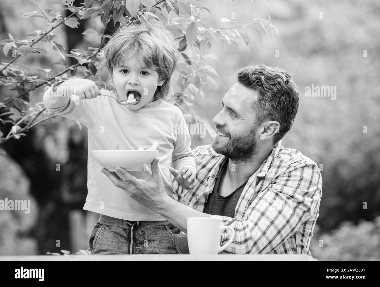 Family enjoy homemade meal. Father son eat food and have fun. Nutrition ...