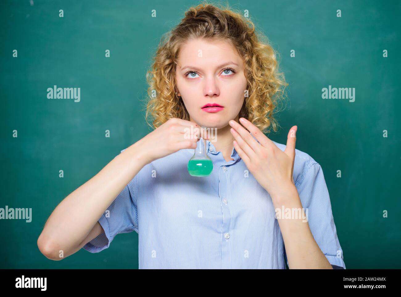 smelling sample. chemistry research results. student with beaker ...