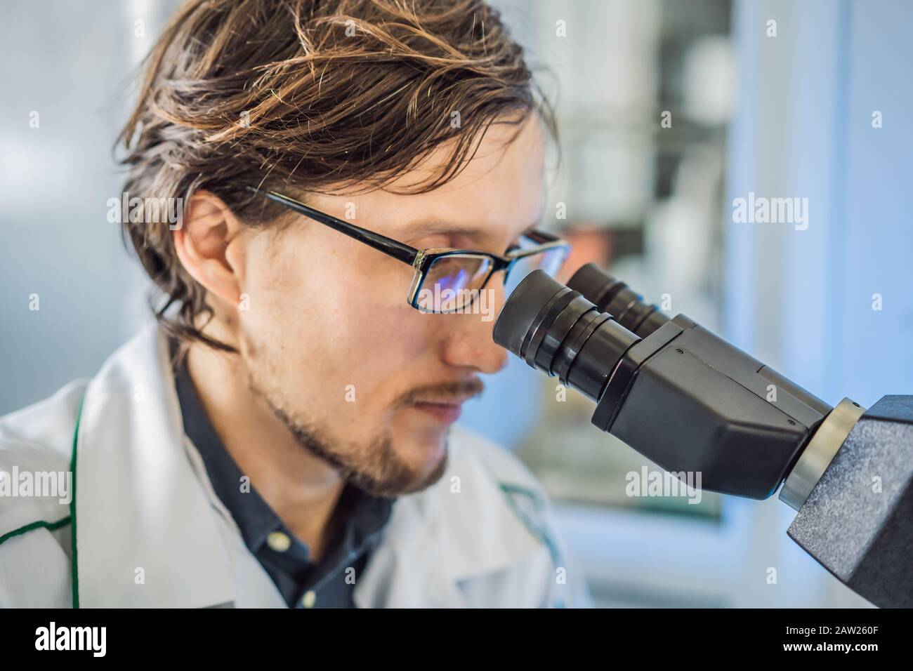 Portrait of caucasian male chemist scientific researcher using ...