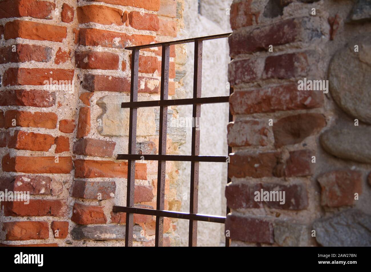 Ancient grate of a prison or castle, which looks outside in the winter ...