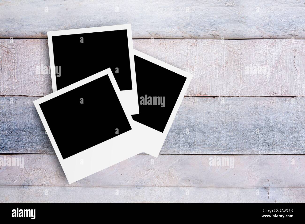 Three photo frames on a white wooden desktop. Top down view and mock up ...