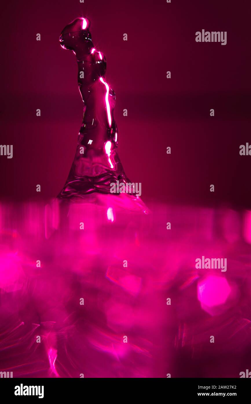 Water splash figure in pink Stock Photo - Alamy