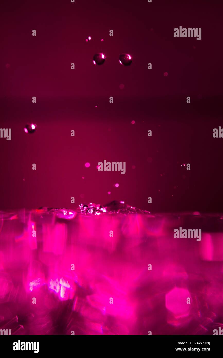 Water splashing bubbles in pink color Stock Photo - Alamy