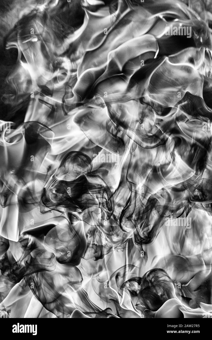 Abstract puffs of natural black smoke and white huge flame of strong ...
