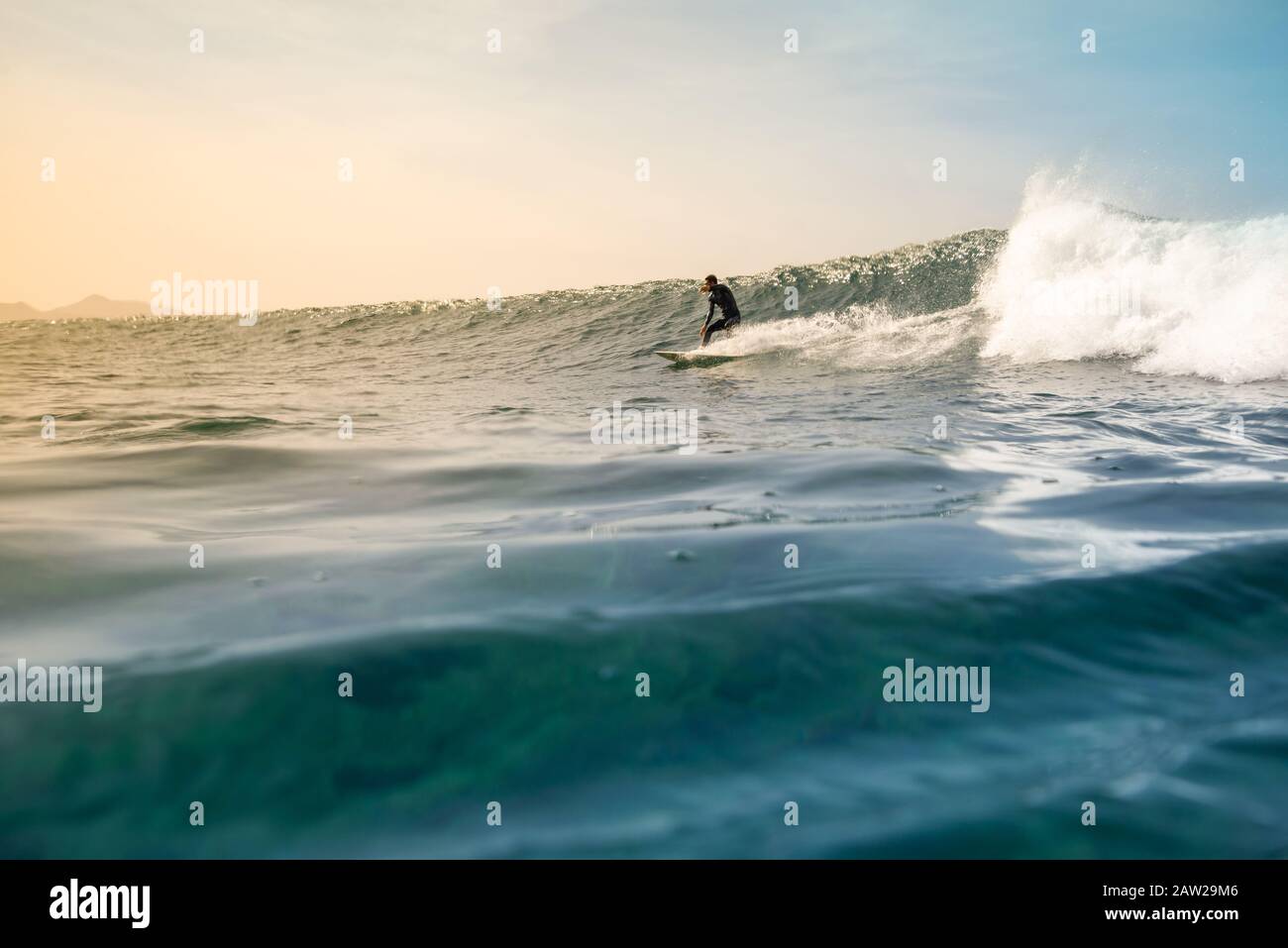 surfer riding waves on the island of fuerteventura Stock Photo - Alamy