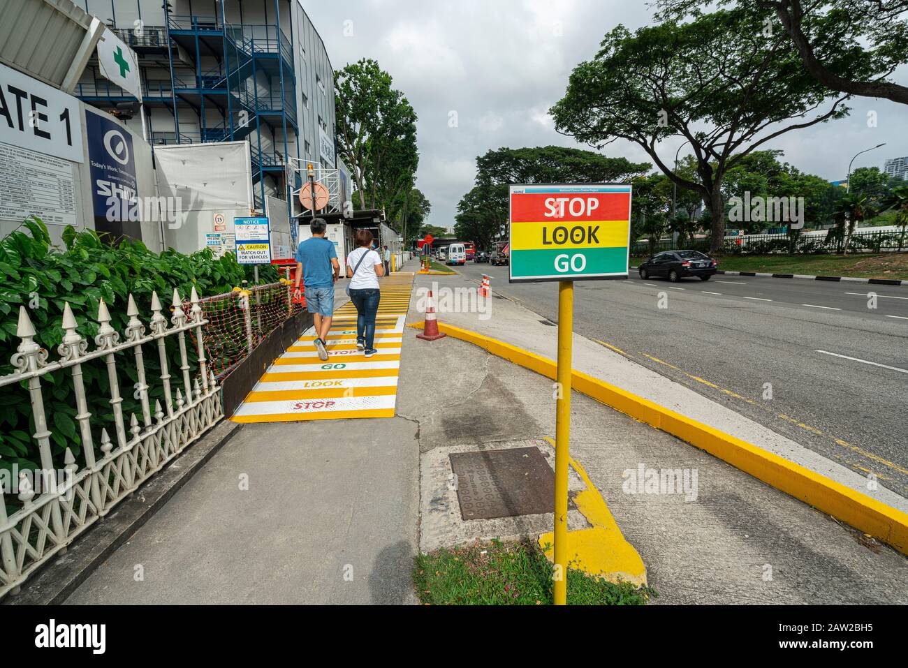 Singapore. January 2020. some signs for crossing a construction site ...