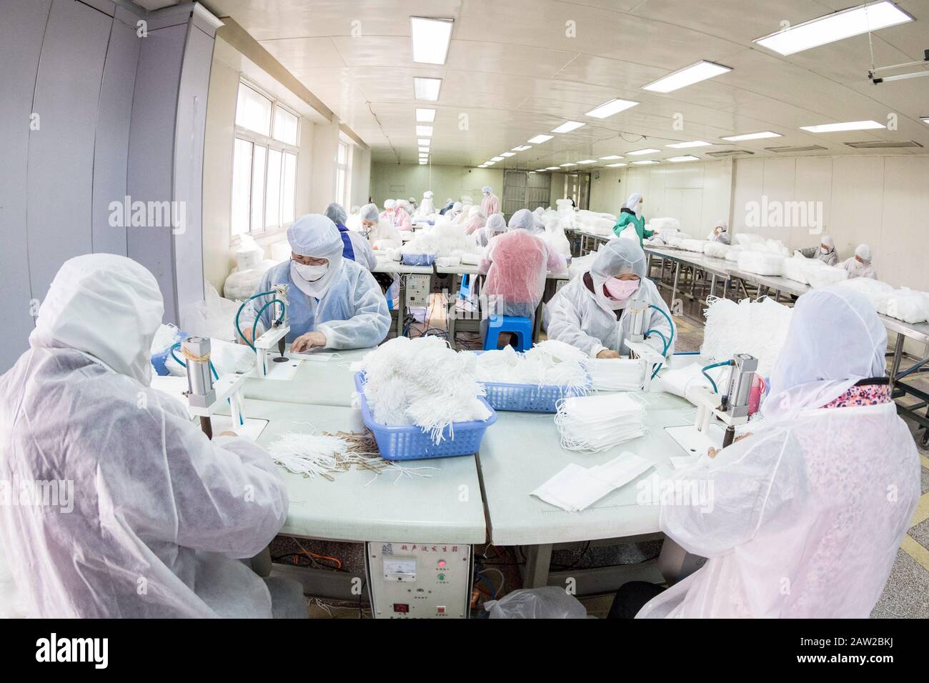 Chinese workers manufacture surgical face masks at the plant of a ...