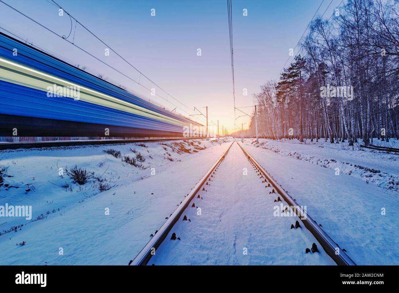 Highspeed train moves fast at winter sunset time Stock Photo - Alamy