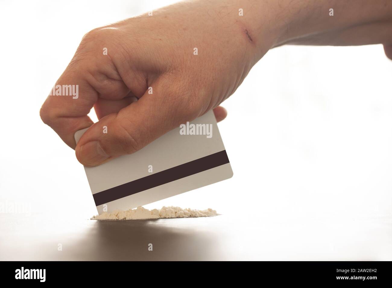 Close up of addict hand with crack cocaine and credit card. Drug dose ...