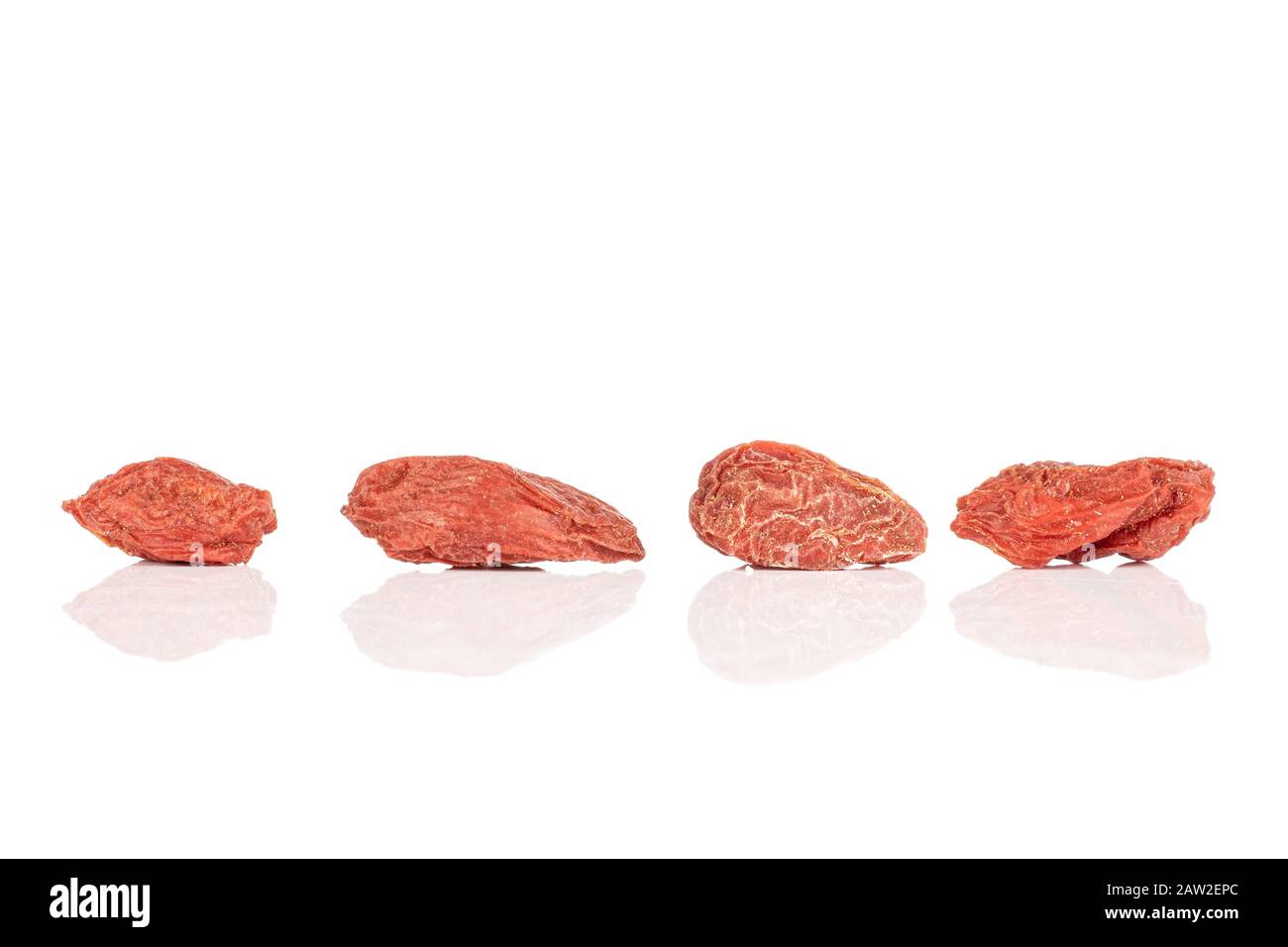 Group of four whole dried red goji isolated on white background Stock ...