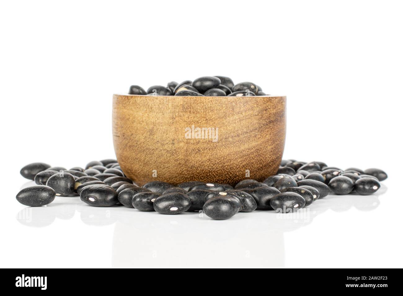 Lot of whole shiny black bean in bamboo bowl isolated on white ...
