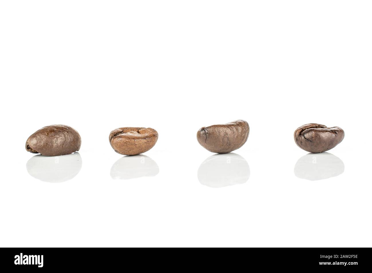 Group of four whole fresh coffee bean isolated on white background ...