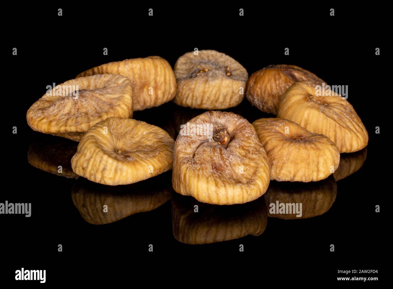 Group of eight whole dried fig circle isolated on black glass Stock ...
