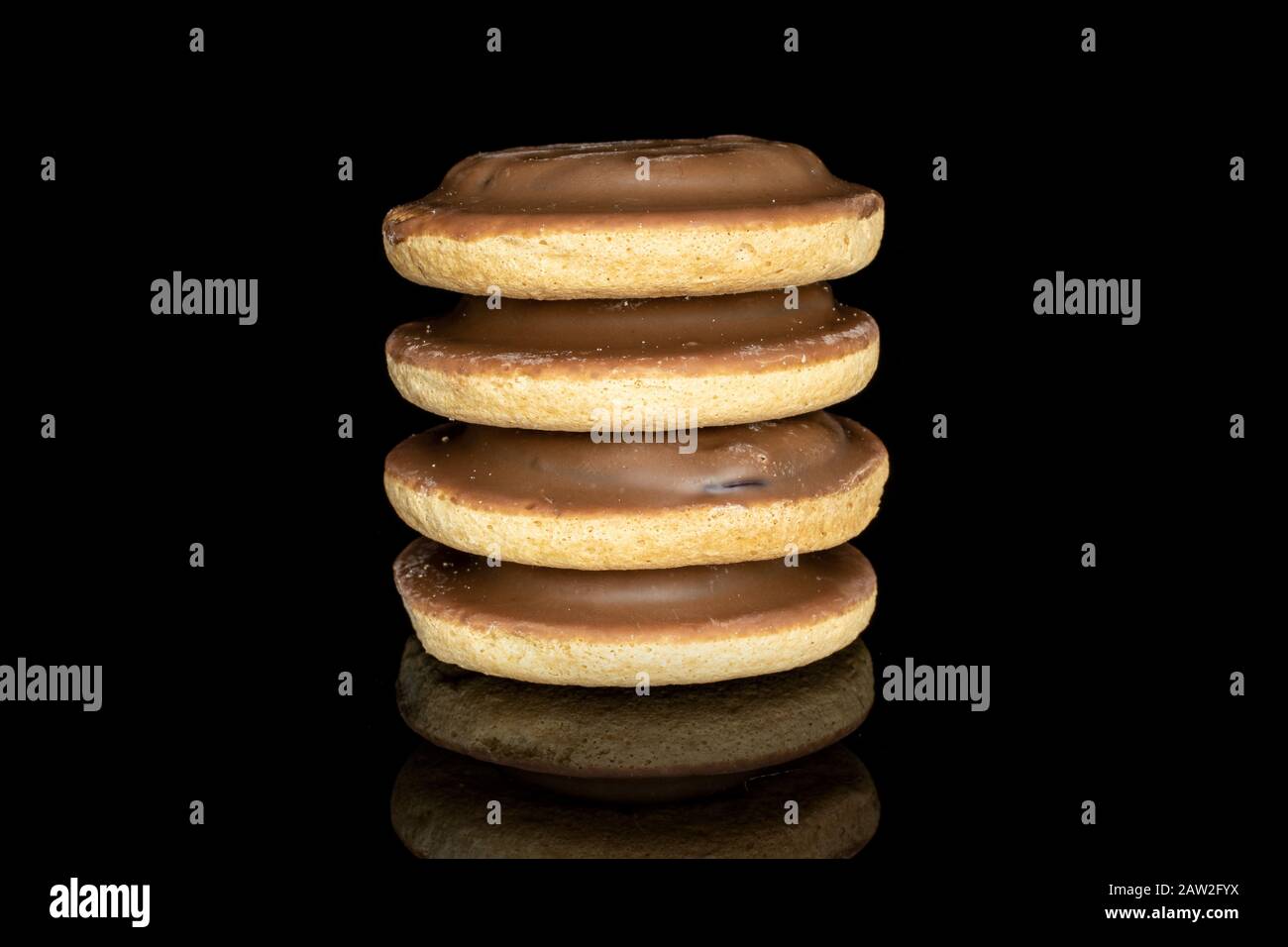 Group of four whole chocolate biscuit tower isolated on black glass ...