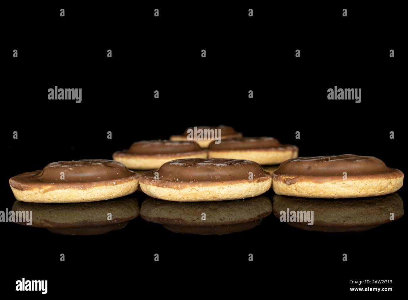 Group of six whole chocolate biscuit triangle isolated on black glass ...