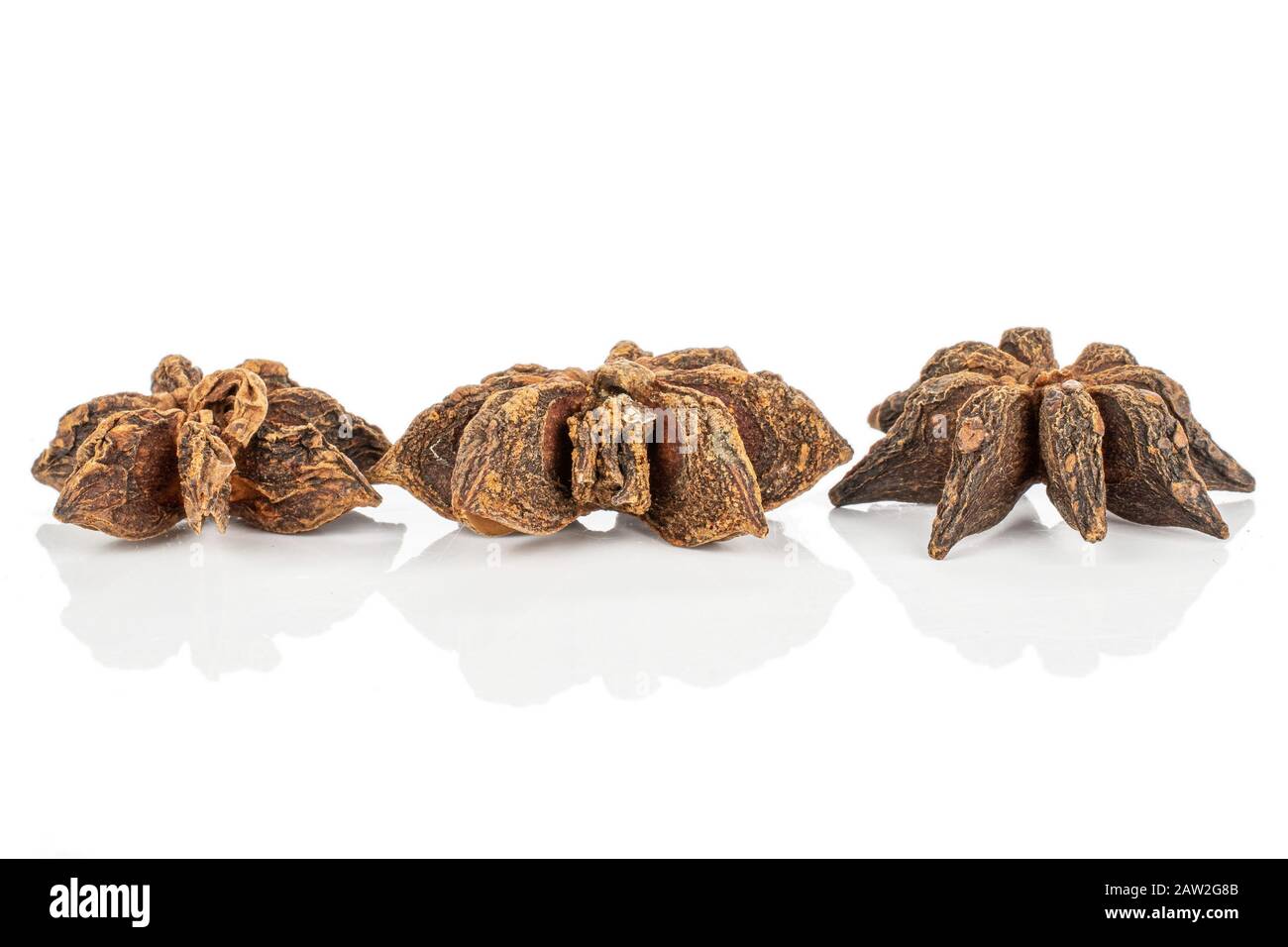 Group of three whole aromatic brown badian isolated on white background ...