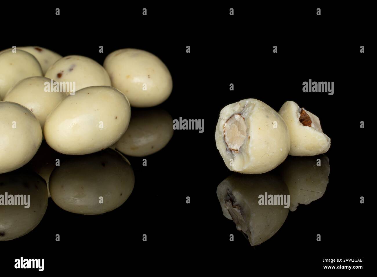 Group of lot of whole two halves of coated white almond nut ...