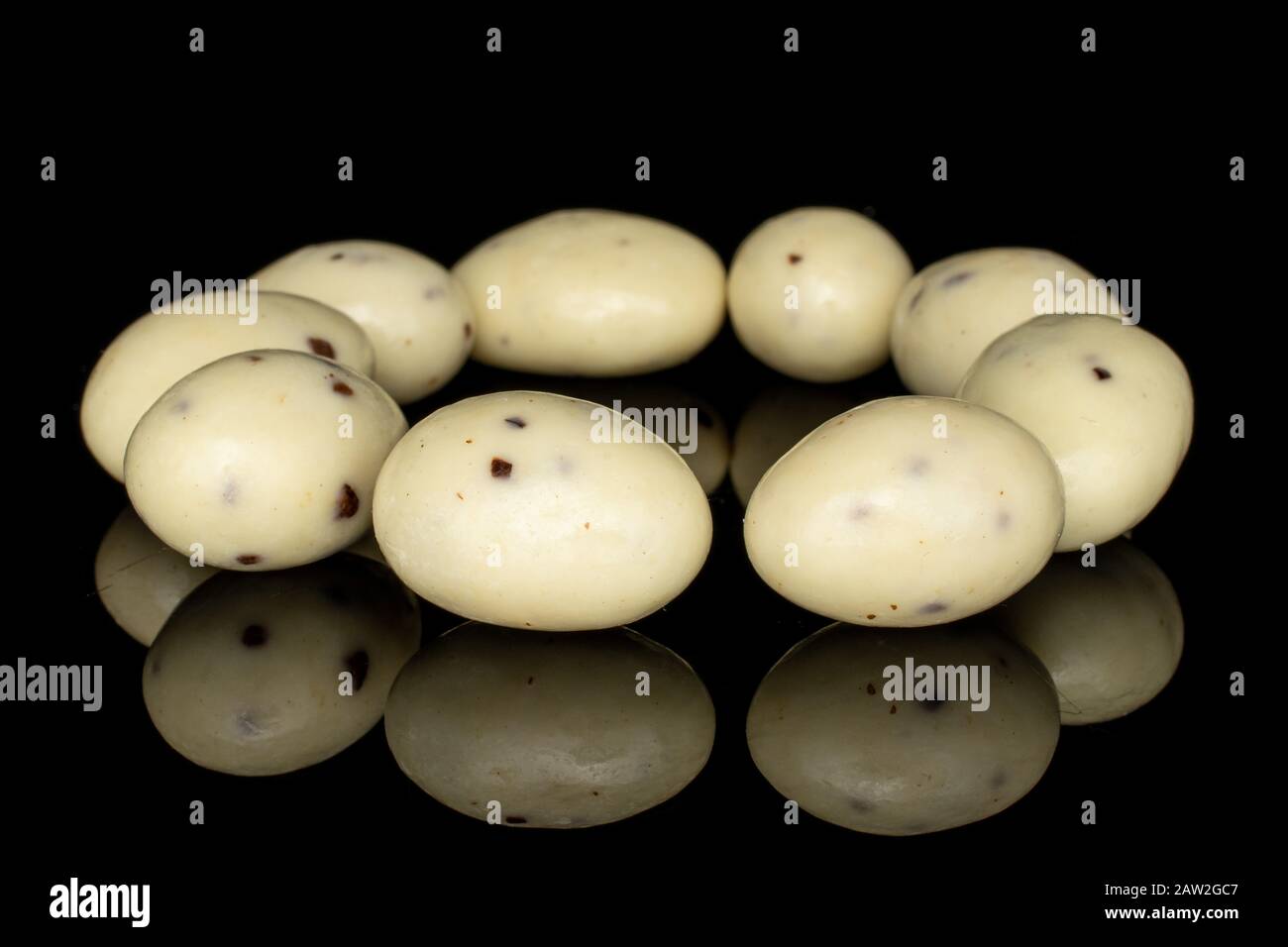 Group of nine whole coated white almond nut stracciatella isolated on ...