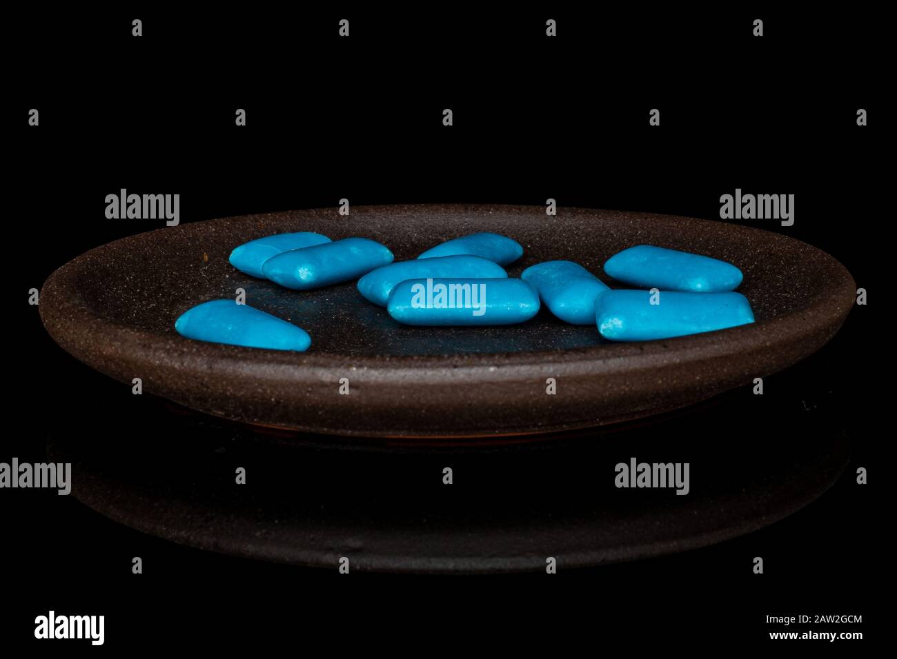 Group of nine whole blue chewing gum with brown ceramic coaster ...