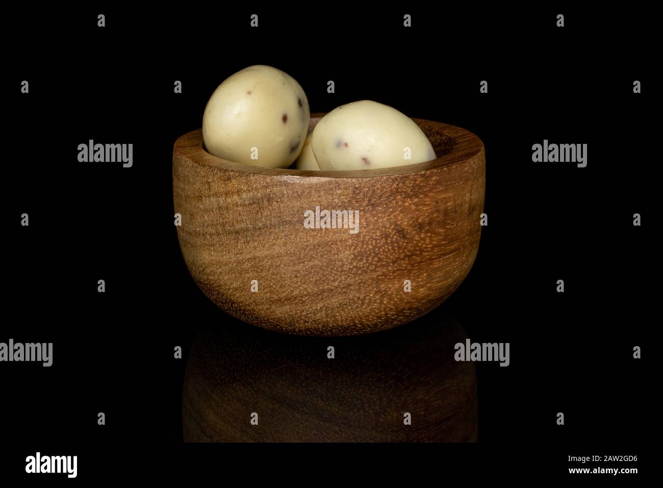 Group of two whole coated white almond nut stracciatella in bamboo bowl ...