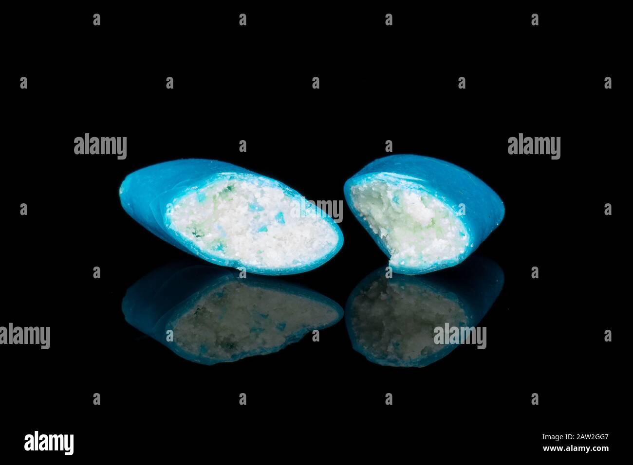Group of two halves of blue chewing gum isolated on black glass Stock ...