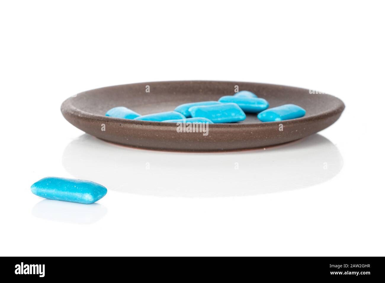 Lot of whole light blue chewing gum with brown ceramic coaster isolated ...