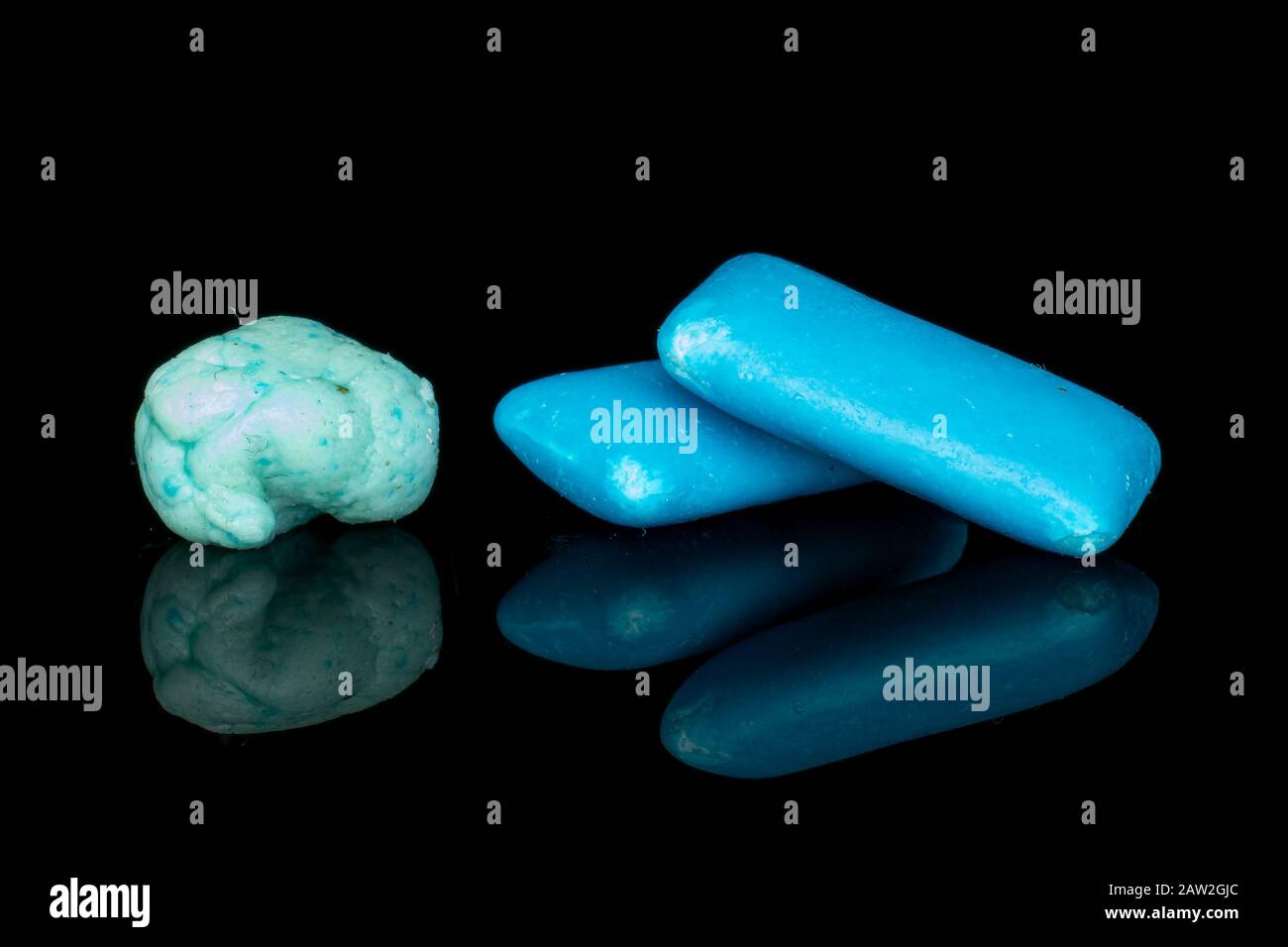 Group of two whole blue chewing gum with one bolus isolated on black ...