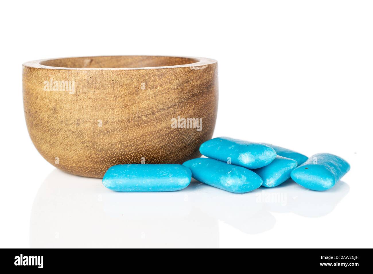 Lot of whole blue chewing gum in bamboo bowl isolated on white ...
