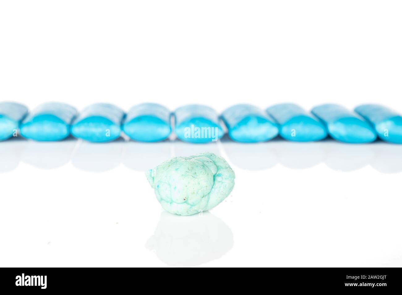 Group of nine whole blue chewing gum one bolus in focus isolated on ...