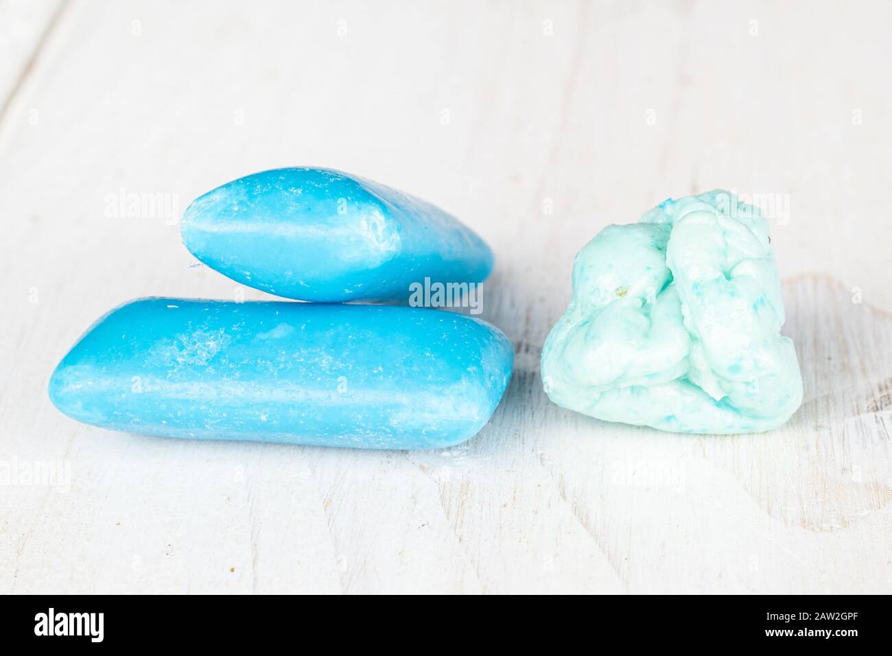 Group of two whole blue chewing gum with one bolus on white wood Stock ...