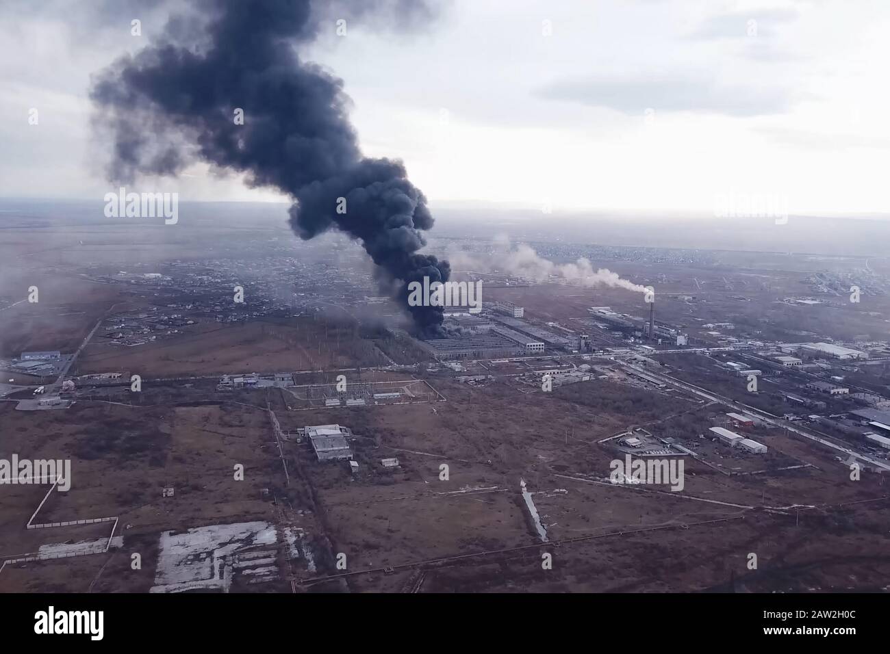 A major fire at the factory. dark puffs of smoke from buildings Stock ...
