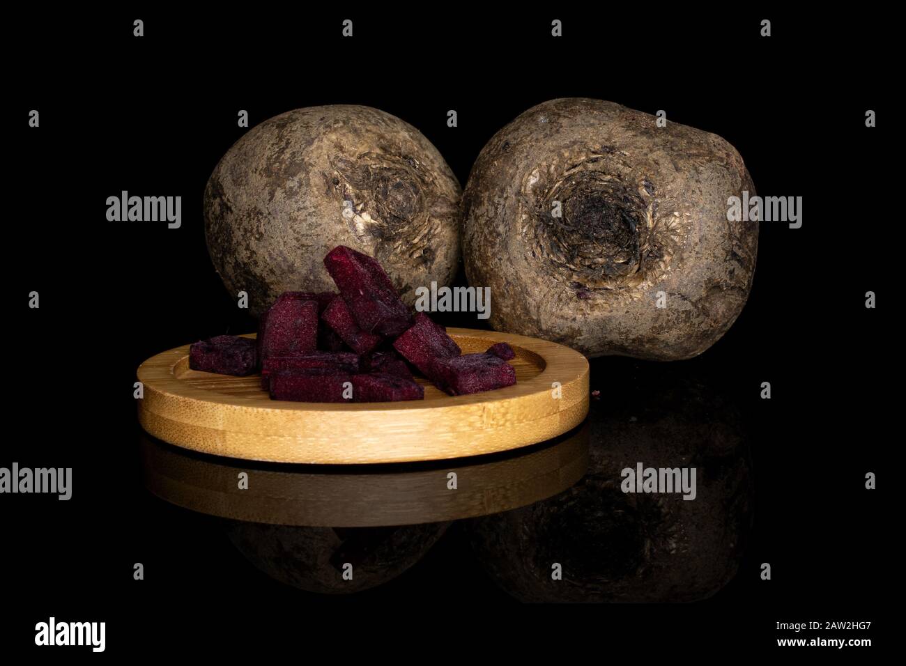 Group of two whole lot of pieces of raw sweet beetroot on round bamboo ...