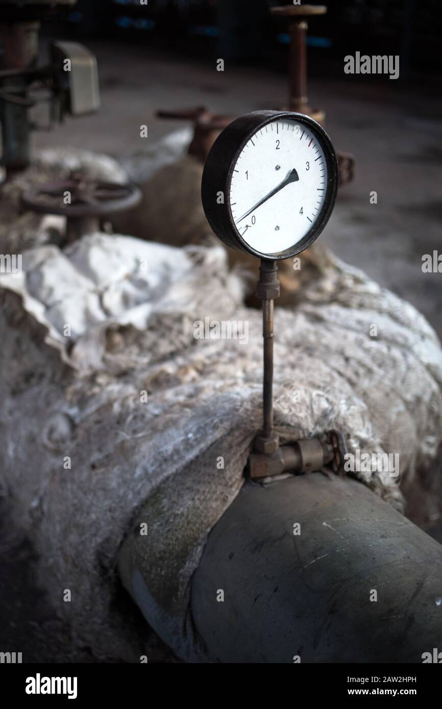 Chemical plant equipment. Old pressure control sensor pressure gauge on ...